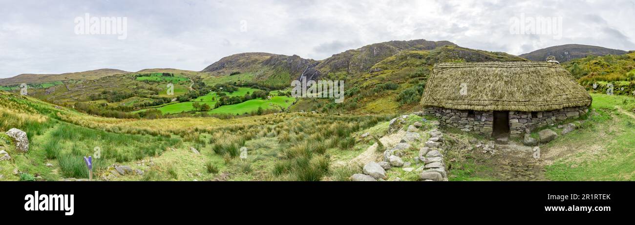Panorama picture of typical Irish landscape with medieval stone house ...