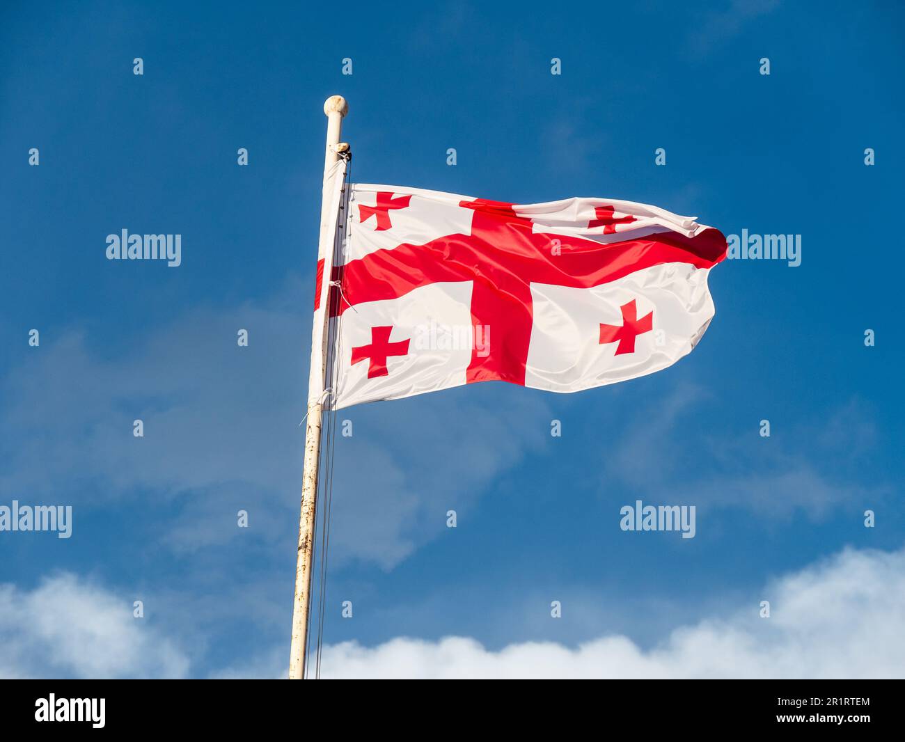 Georgian Flag flying against a blue background on a windy winter ...