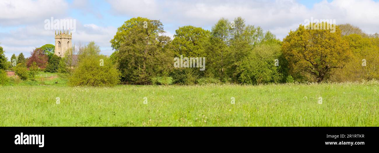 Panorama of lush english landscape with medieval church tower in ...