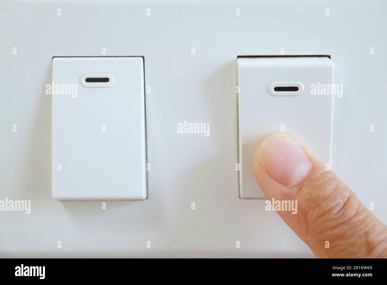 Finger pushing a switch for turn off light Stock Photo - Alamy
