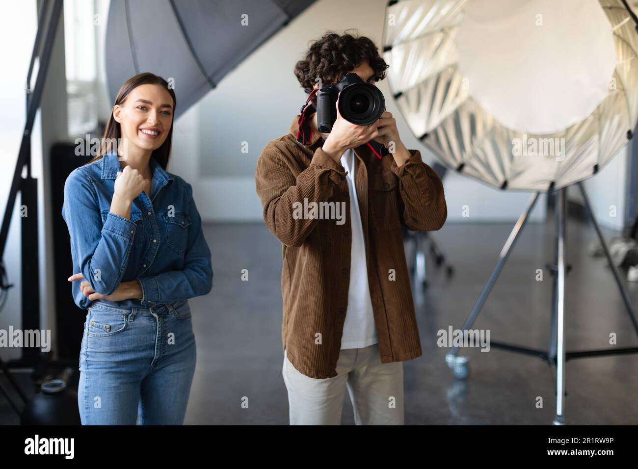 Capturing the moment. Male photographer with his trusty assistant doing ...