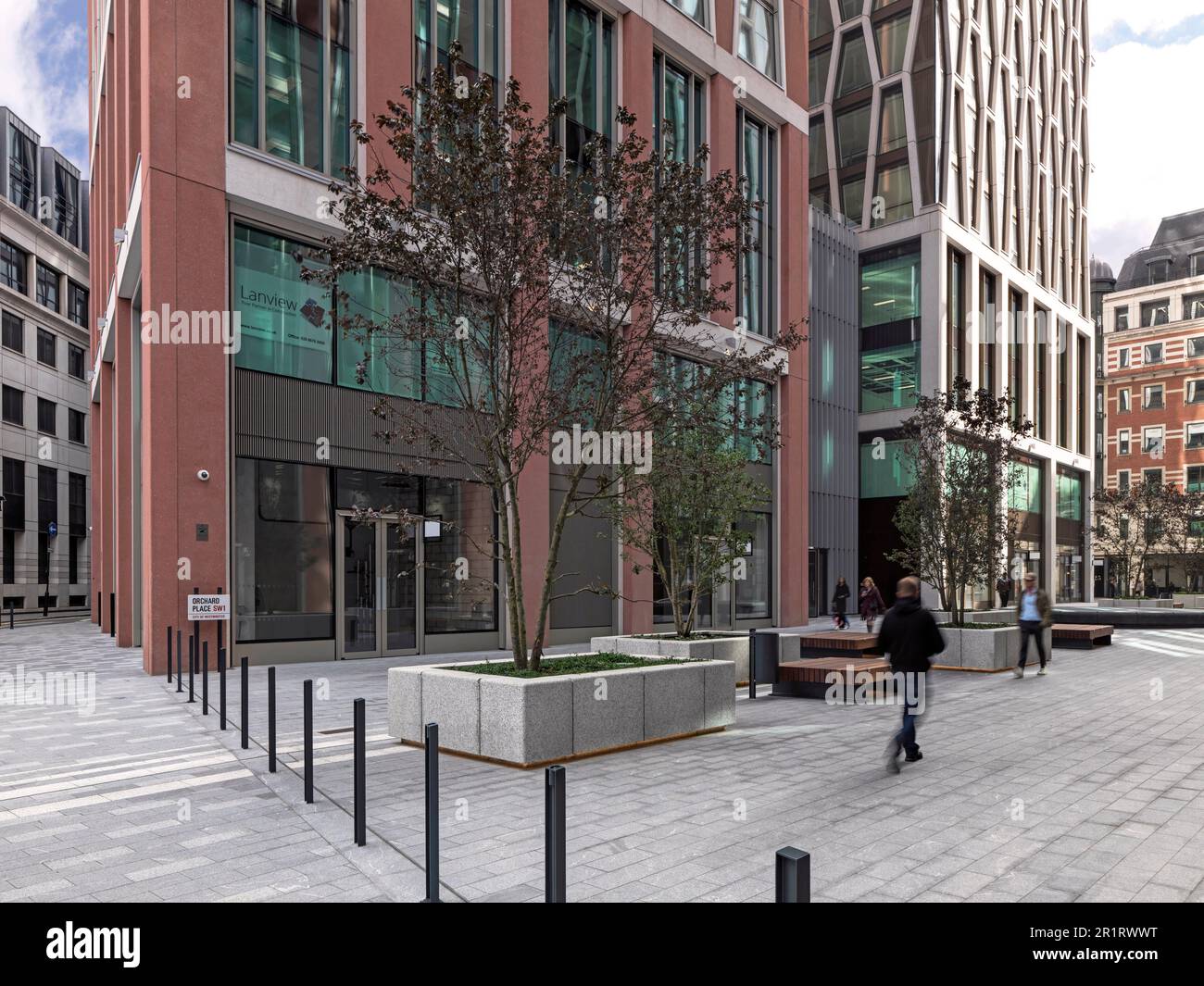 Pedestrianised passage between building complex. The Broadway, London ...