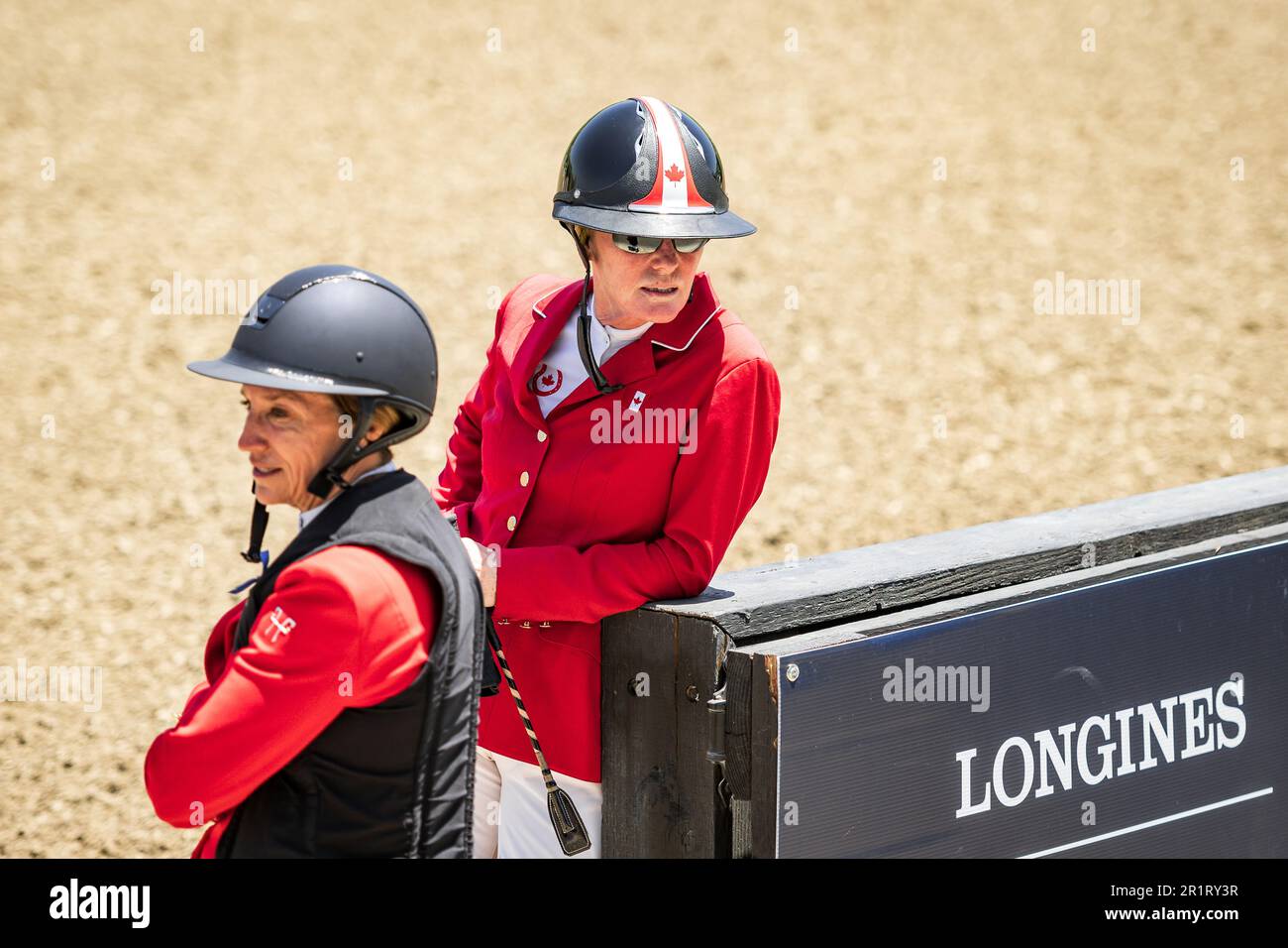 Team Canada rider Beth Underhill, right speaks with Team USA rider ...