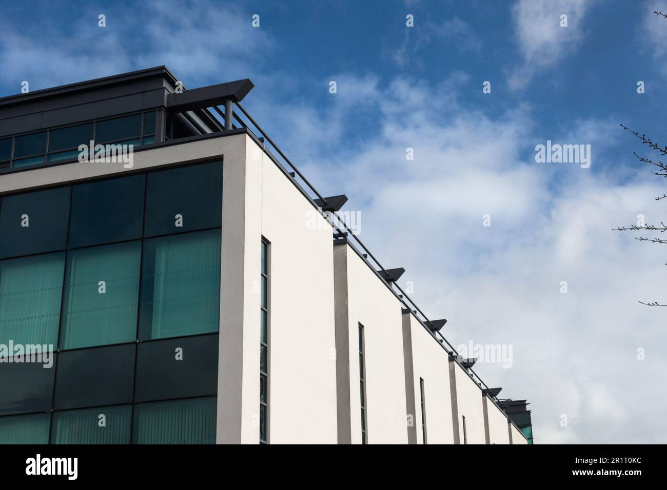 A sleek modern office building with blue skies Stock Photo - Alamy