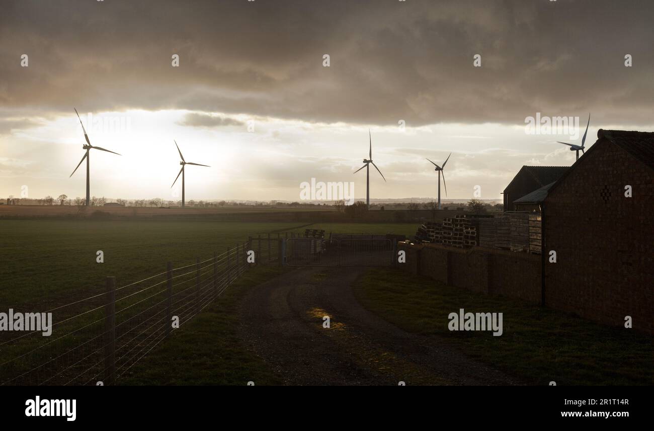 A barn in the countryside with wind turbines in the background Stock ...