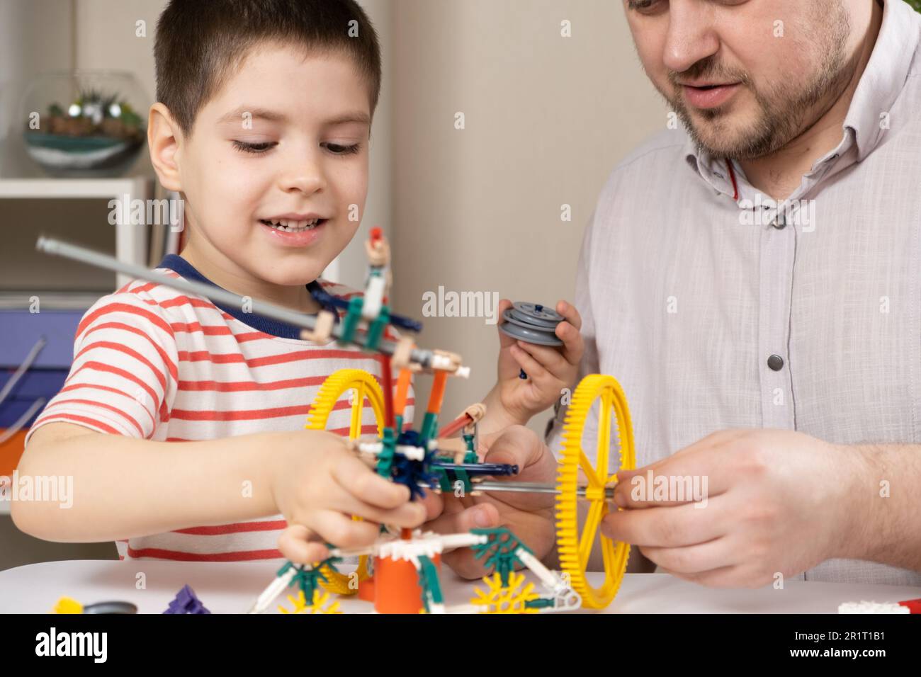 Dad and son build figures from the constructor. Spending time together ...