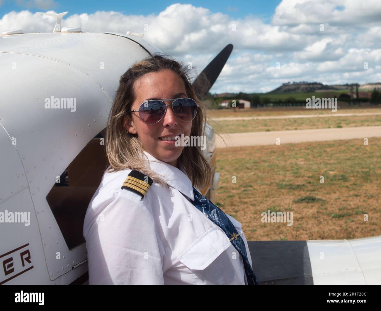 A Caucasian female pilot posing near her airplane Stock Photo - Alamy