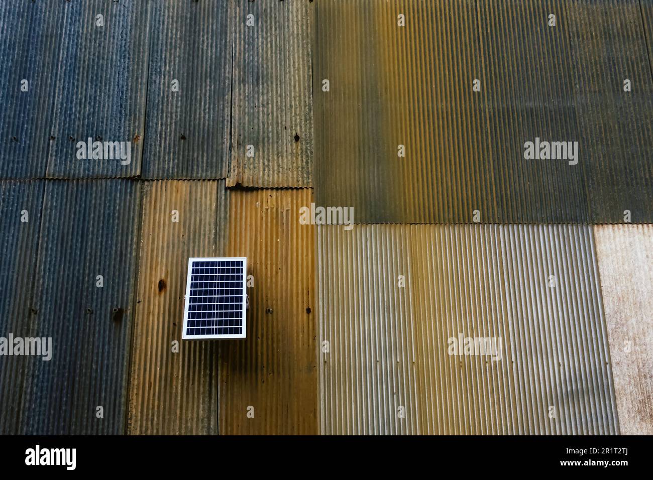 Solar panel attached on old zinc wall. Electric solar panel on the ...