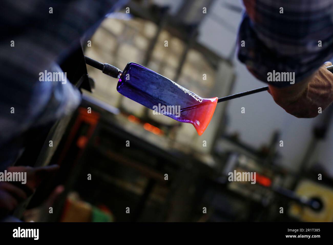 Bill Burch of Pinzette Glass works on a piece in his studio on Friday ...