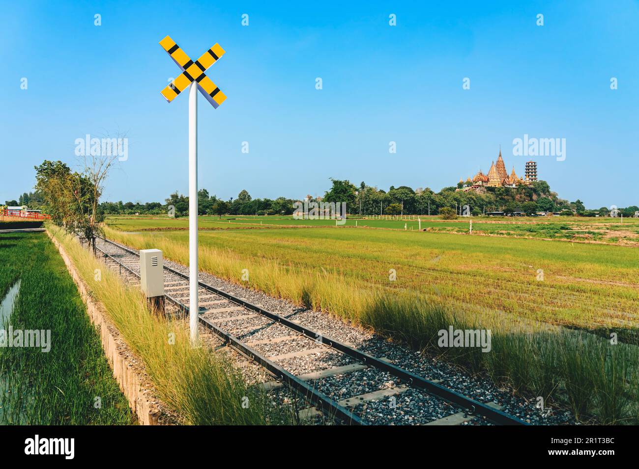 Beautiful view of the sign pole and train route through lush rice ...