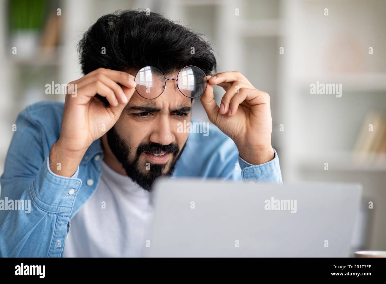 Error. Confused Indian Man Looking At Laptop Screen And Taking Off ...