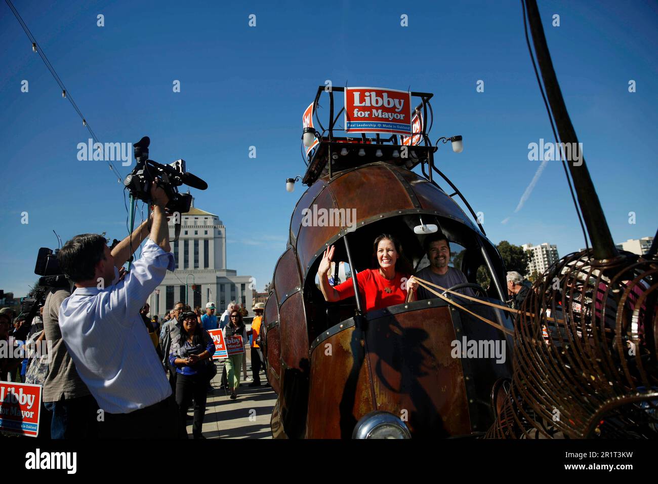 Oakland mayor-elect Libby Schaaf (center in red) waves as she drives ...