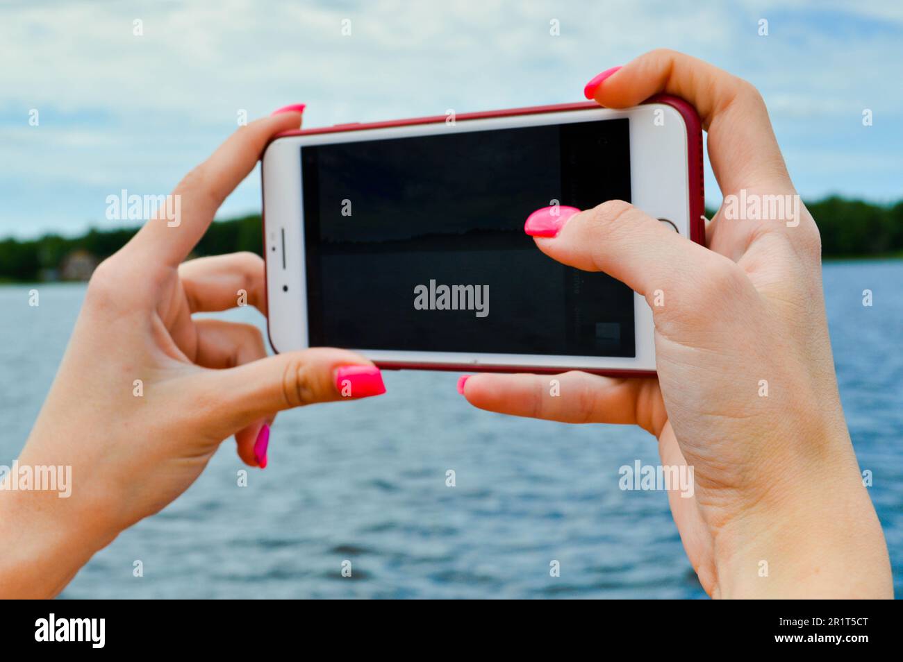 A girl woman with beautiful nails manicure pink orange holds in her ...