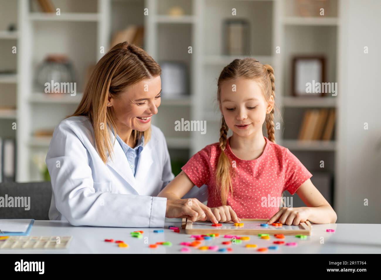 Child Development Specialist Working With Cute Little Girl During ...