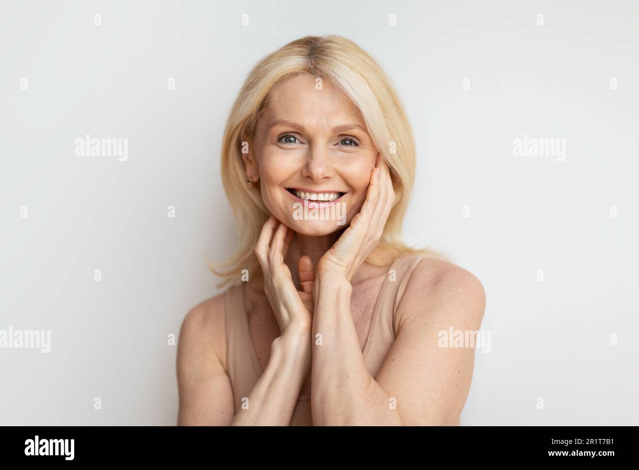 Portrait of happy good-looking senior woman with beautiful skin smiling ...