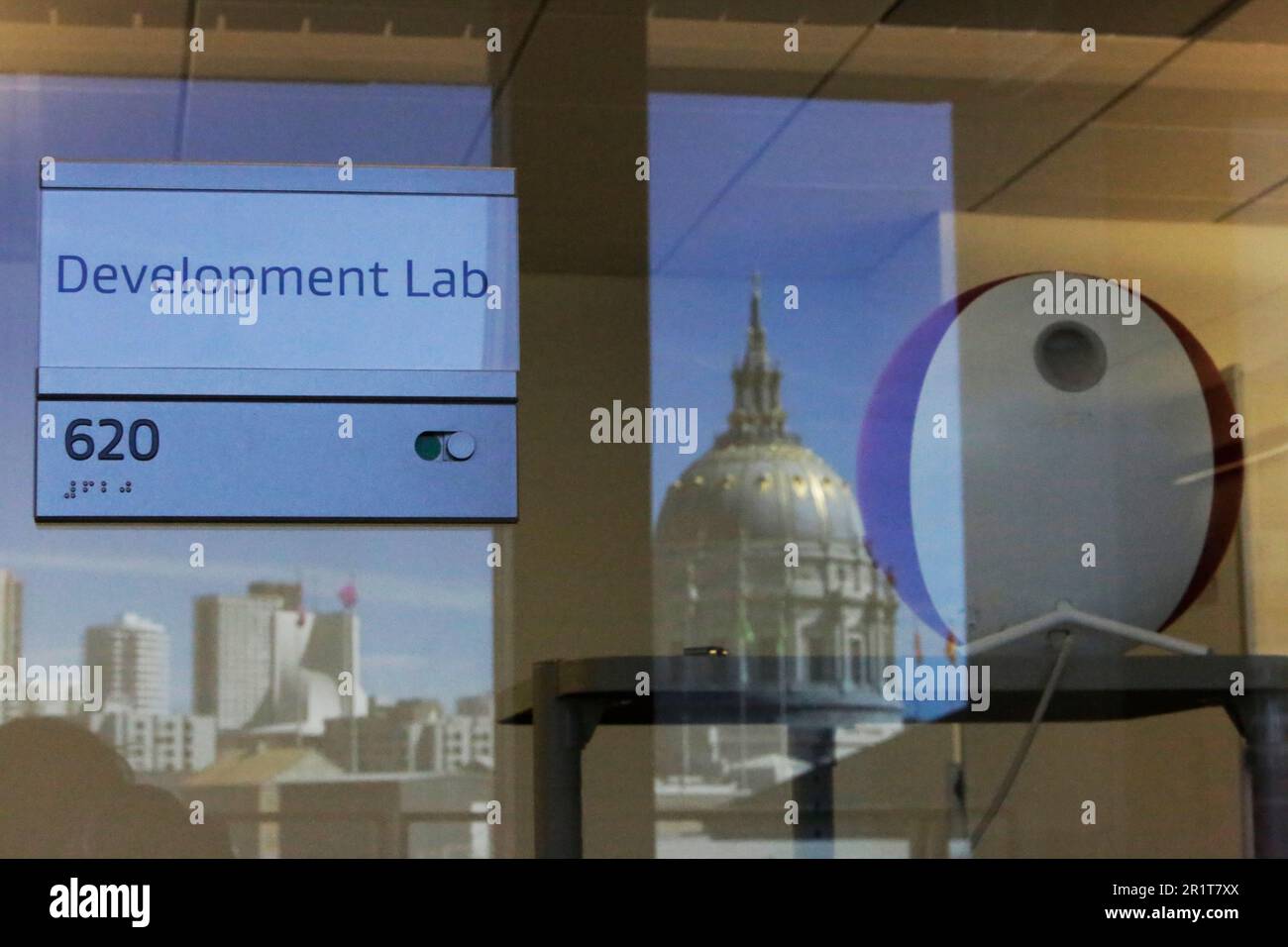 A reflection of City Hall is seen in the glass of a development lab at ...