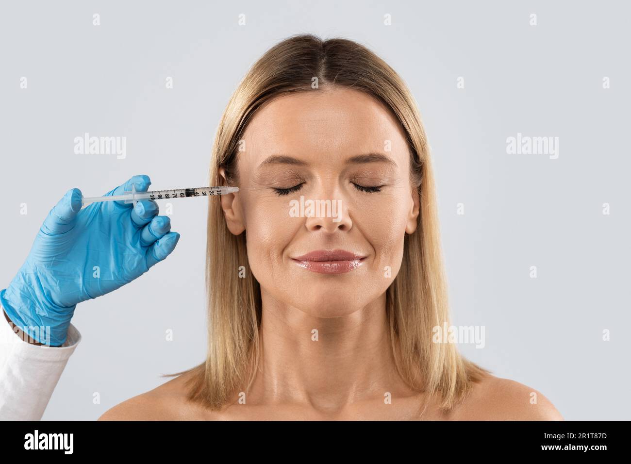 Middle aged woman gets cosmetic eye injection at clinic Stock Photo - Alamy