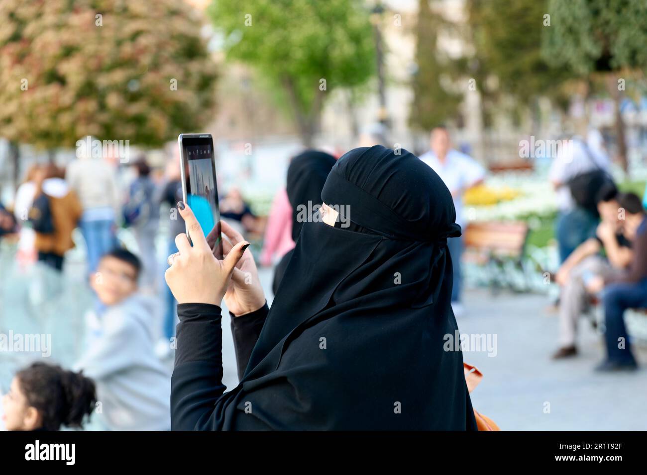 Istanbul Turkey. Veiled woman with tablet Stock Photo - Alamy