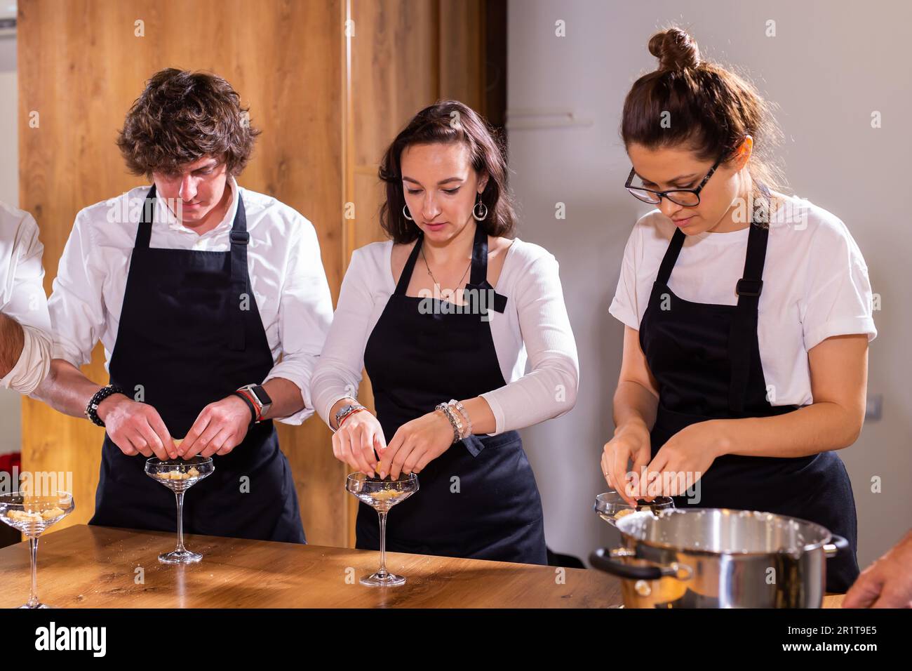 Chef teaching trainees how to make ice cream. Cooking tasty ice cream ...