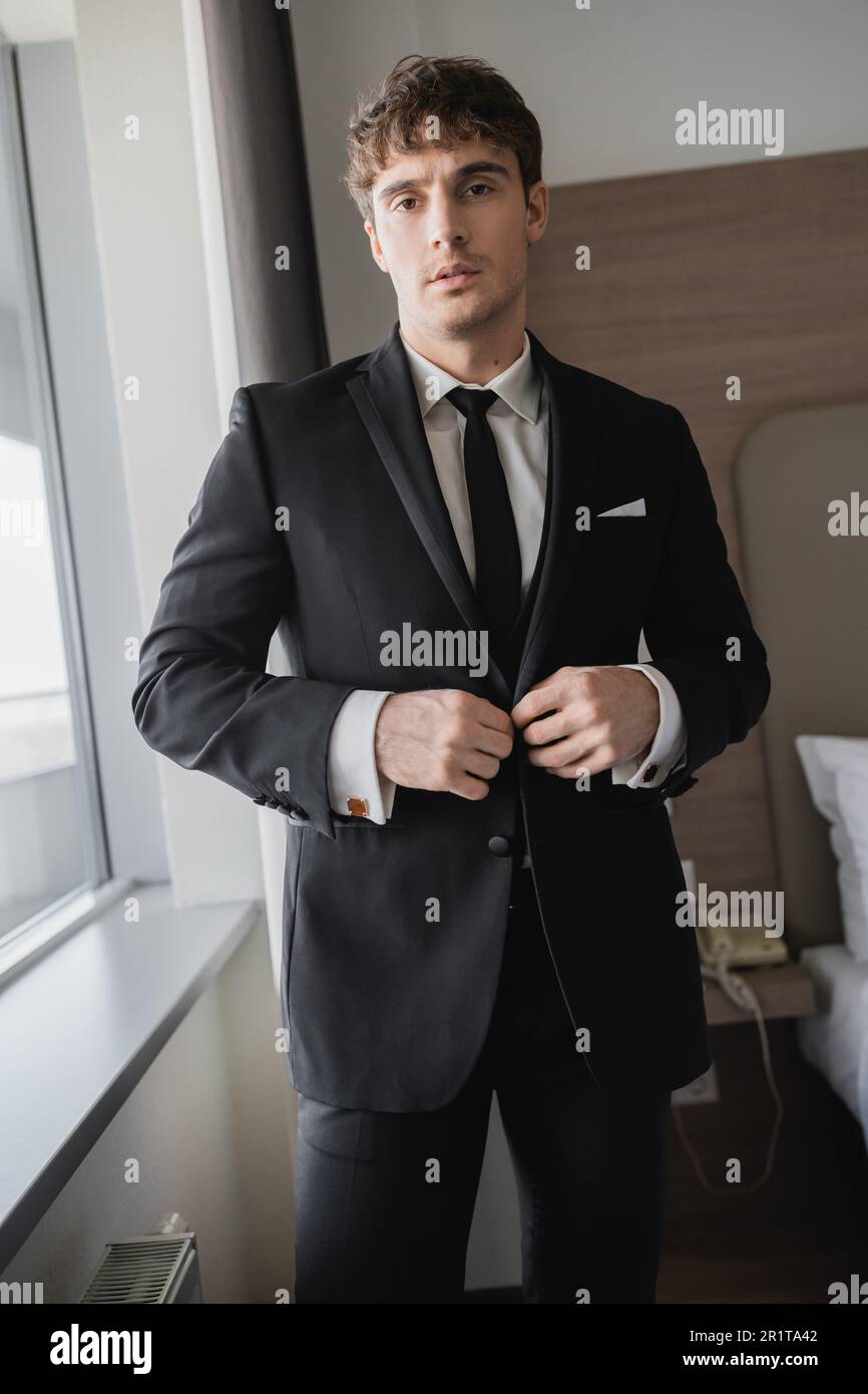 handsome man in classy formal wear with black tie and white shirt ...