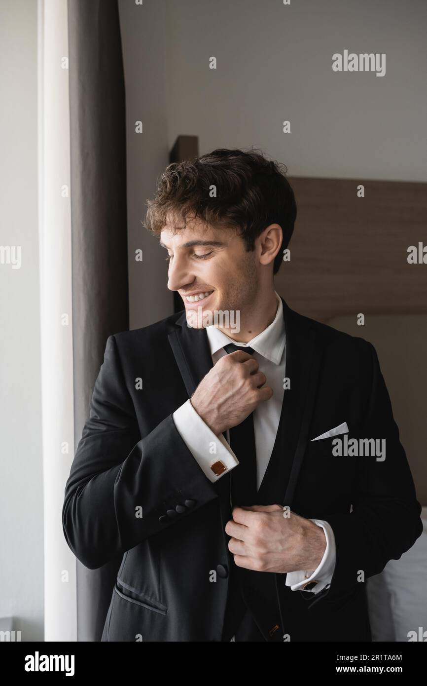 happy and good looking man in classy formal wear with white shirt ...