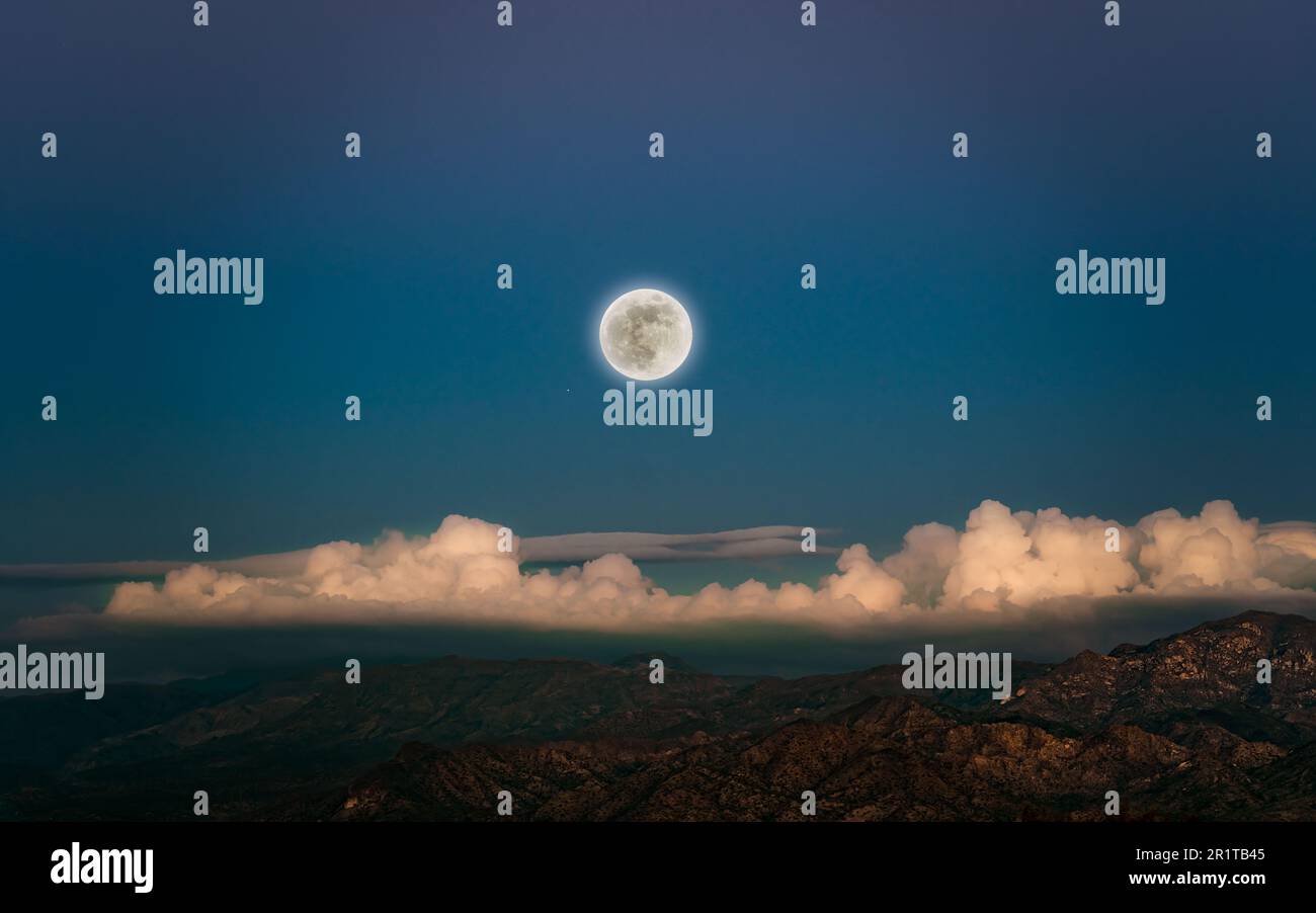 A stunning nightscape featuring an illuminated full moon with Mars on ...