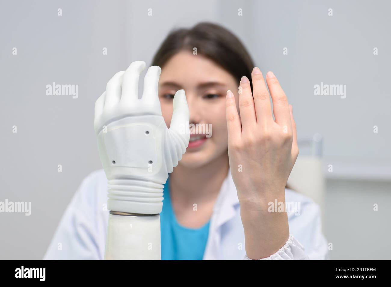 Technician testing robotic bionic arm at prosthetic manufacturing Stock ...