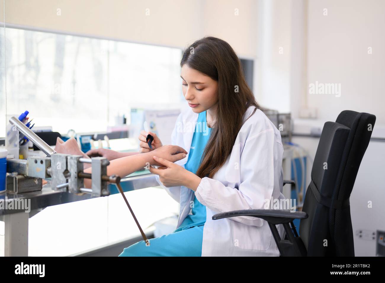 Technician making prosthetic device using grinder to smooth socket ...