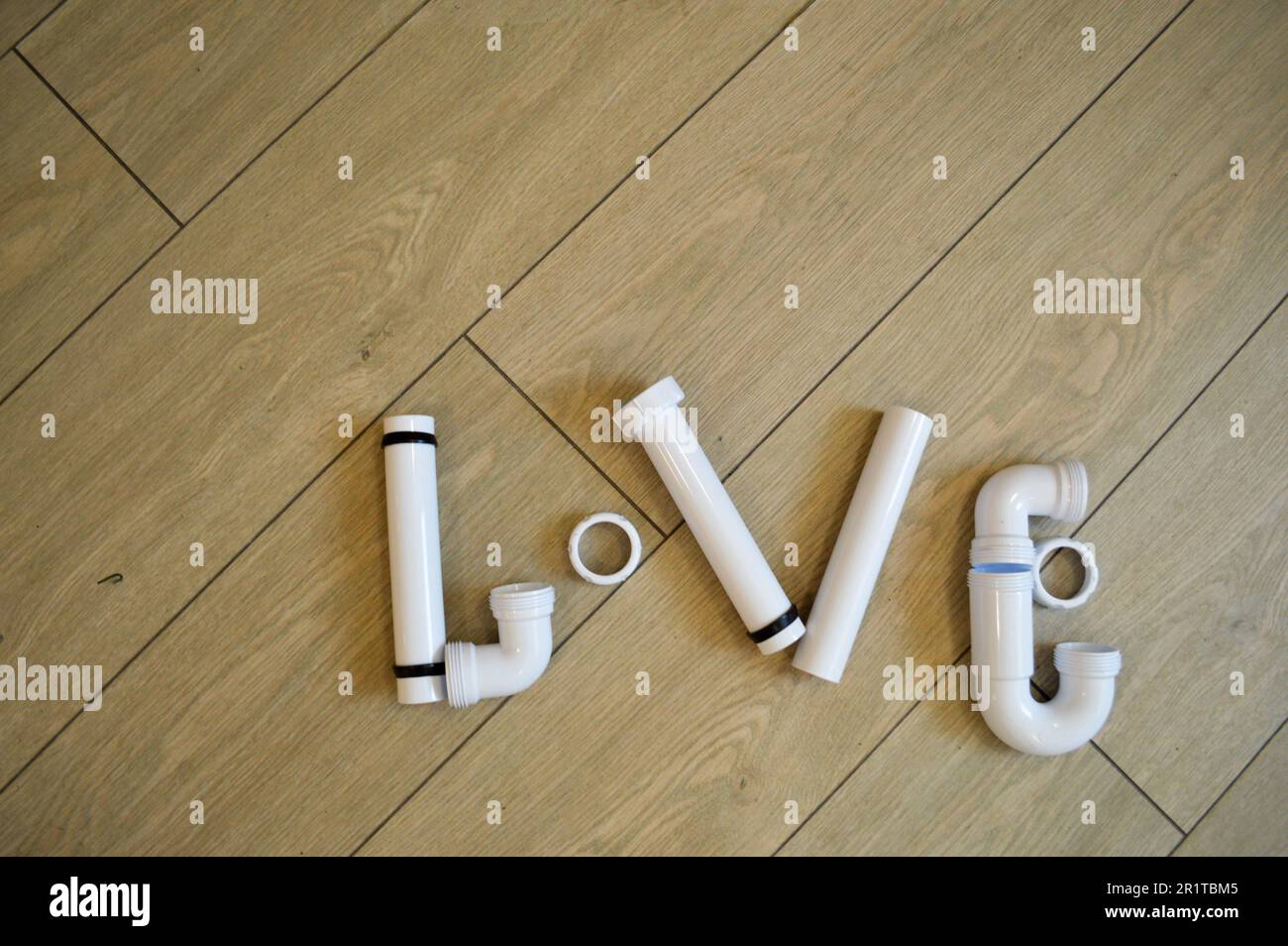 The word love is laid out of plumbing, plumbing white plastic pipes ...