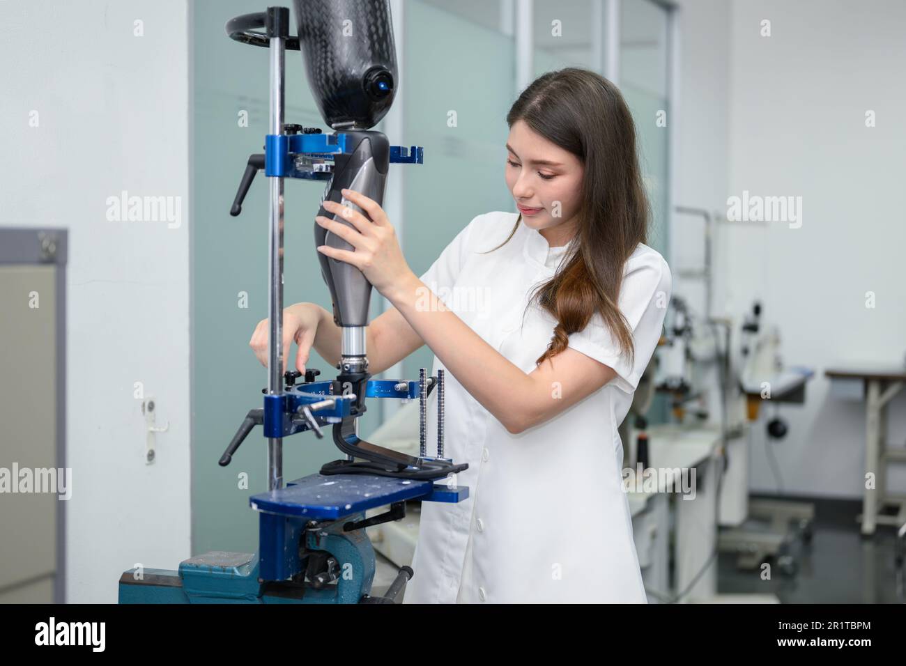 Technician holding prosthetic leg checking and working in laboratory ...