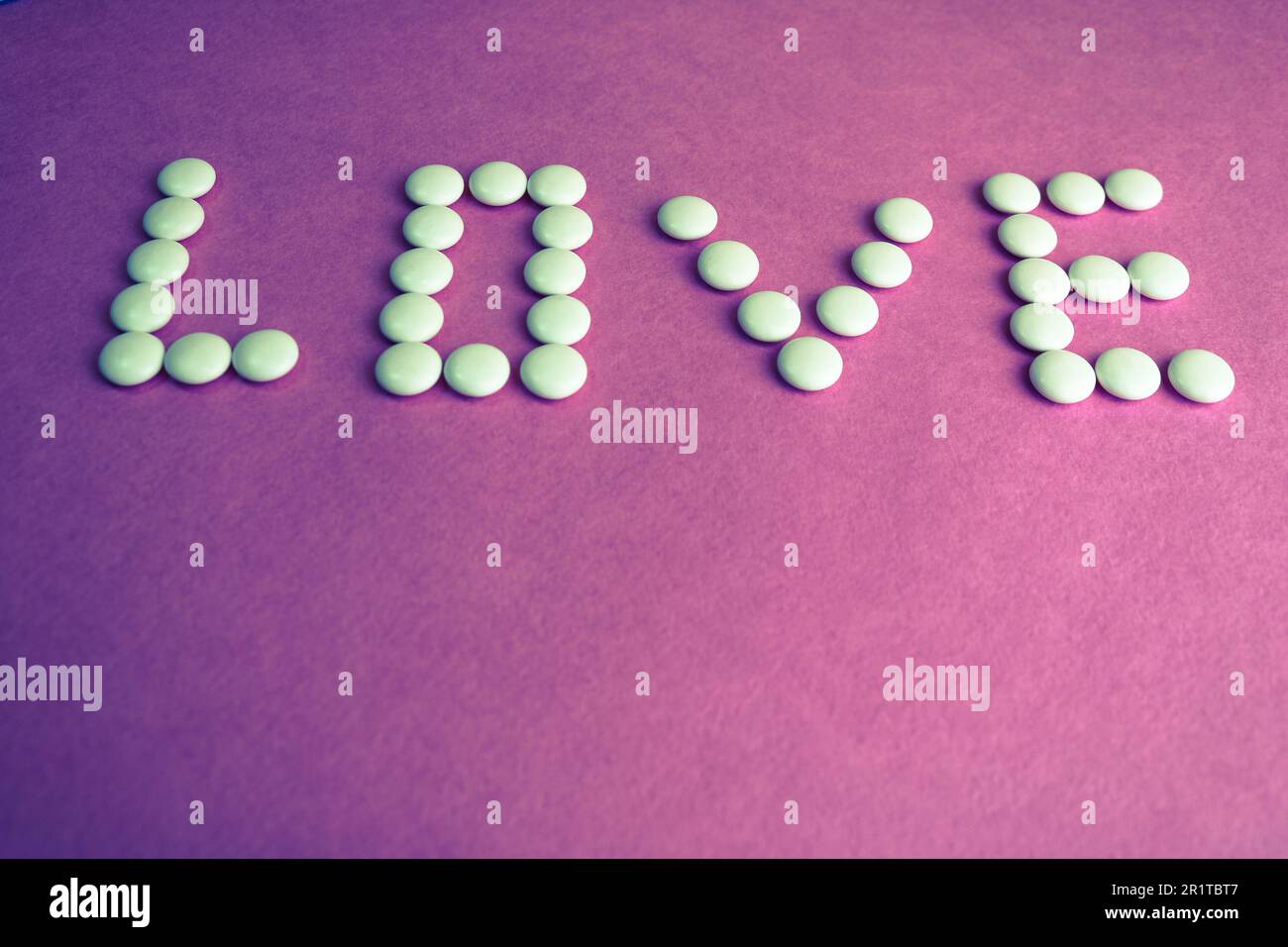 Beautiful inscription love made from white round smooth medical pills ...