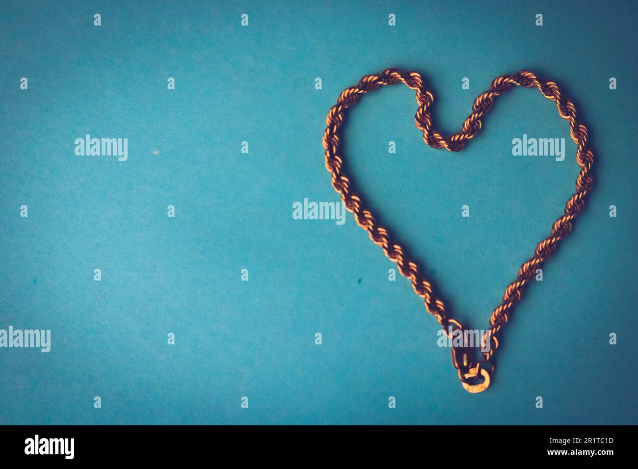 Texture of a beautiful golden dear festive chain of unique weaving in ...