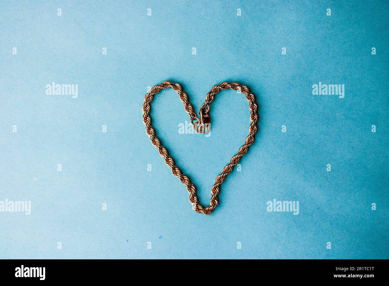 Texture of a beautiful golden dear festive chain of unique weaving in ...