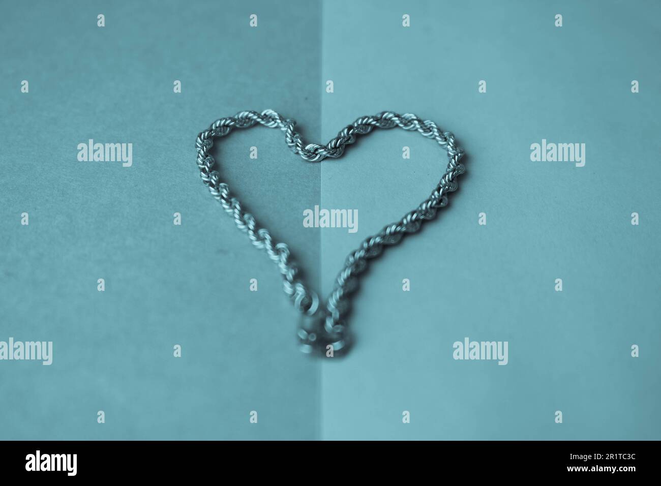 Texture of a beautiful golden dear festive chain of unique weaving in ...