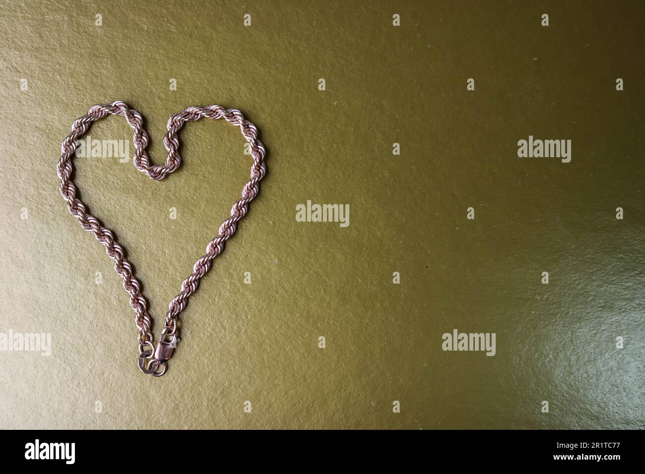 Texture of a beautiful golden festive chain unique weaving in the shape ...