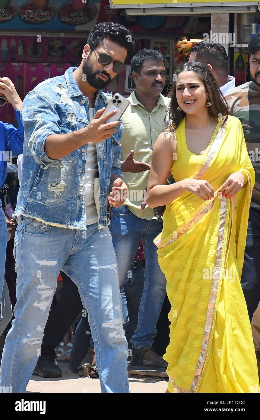 Mumbai, India. 15th May, 2023. (L-R) Bollywood actors Vicky Kaushal holds a mobile phone as Sara ...