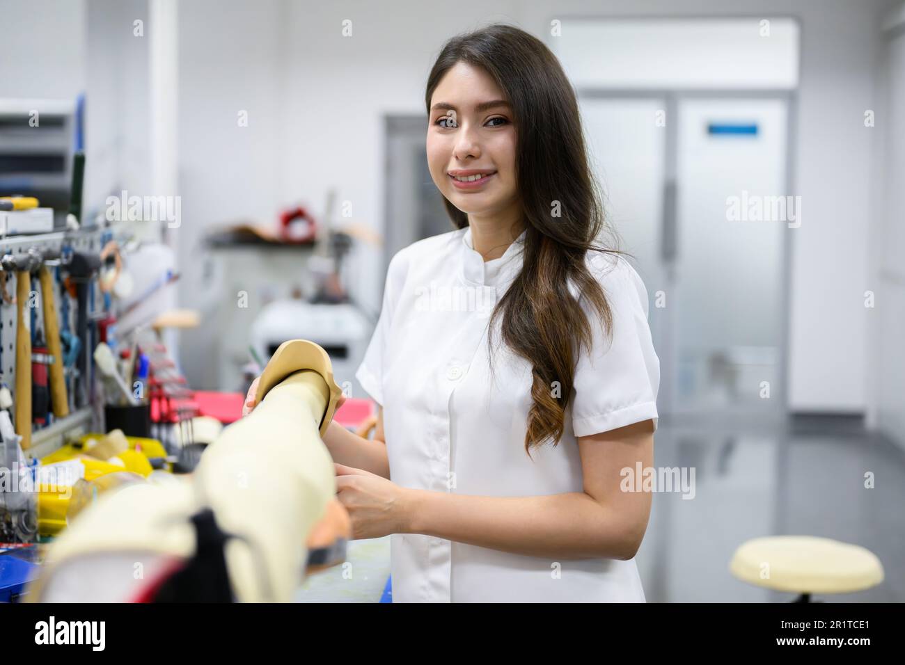 Technician holding prosthetic leg checking and working in laboratory ...