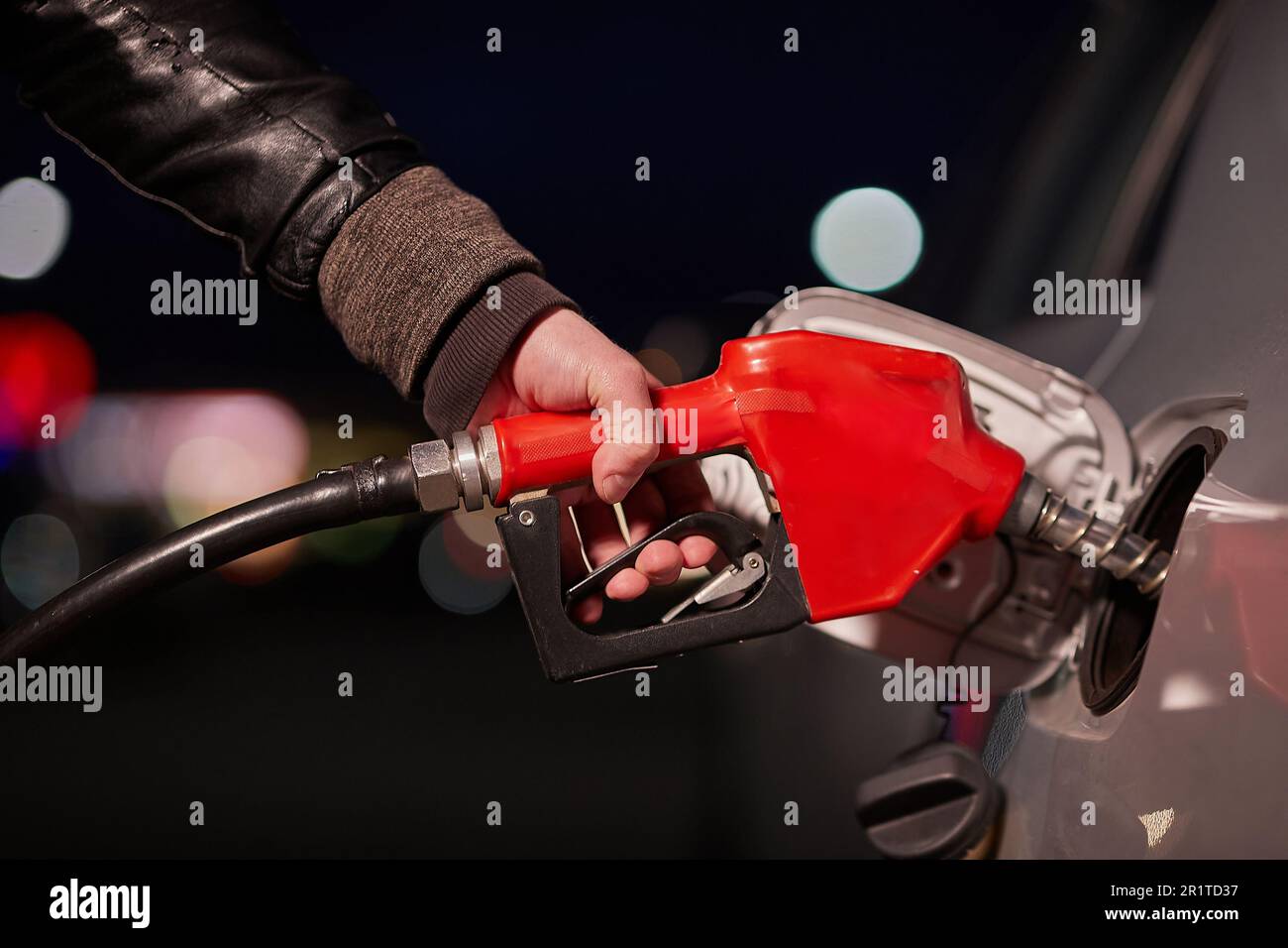 Fuel station nozzle filling car tank Stock Photo - Alamy