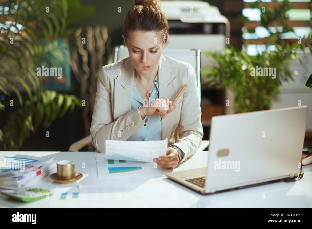 modern 40 years old woman employee in a light business suit in modern ...