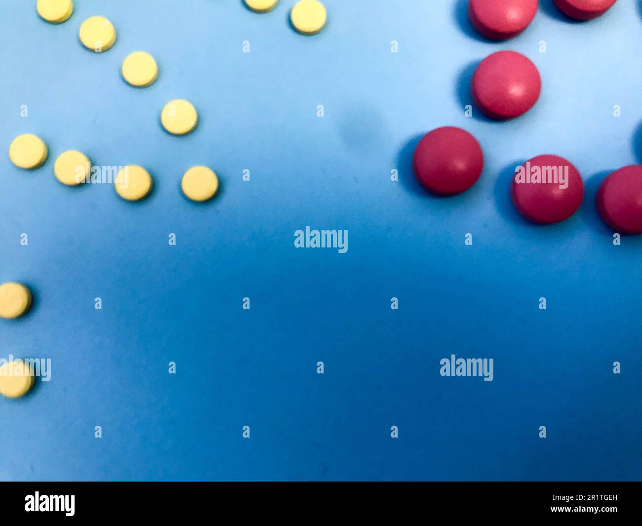 round pink and yellow pills volumetric in the form of letters ...