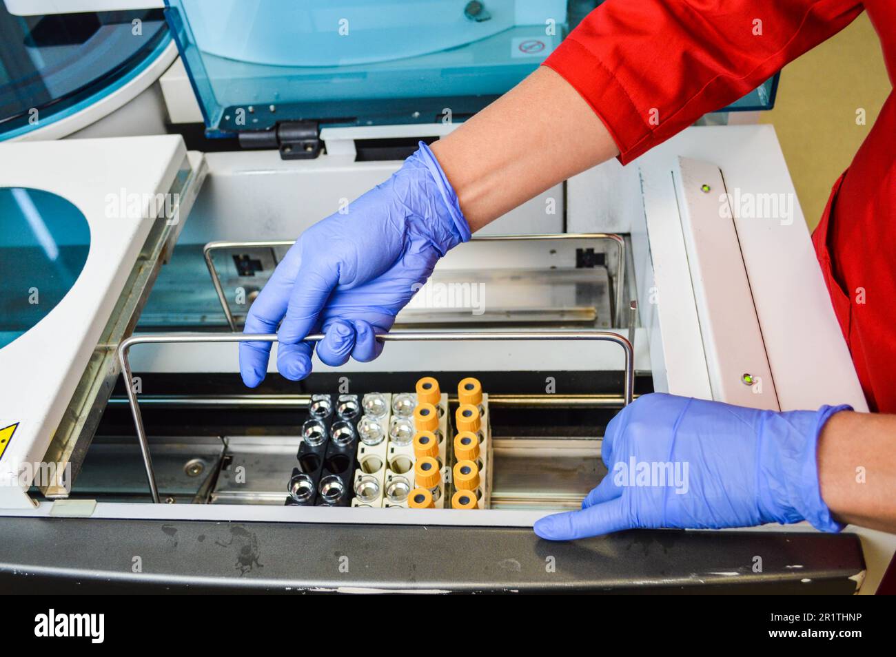 Scientist or medical in lab coat holding test tube with reagent, mixing ...