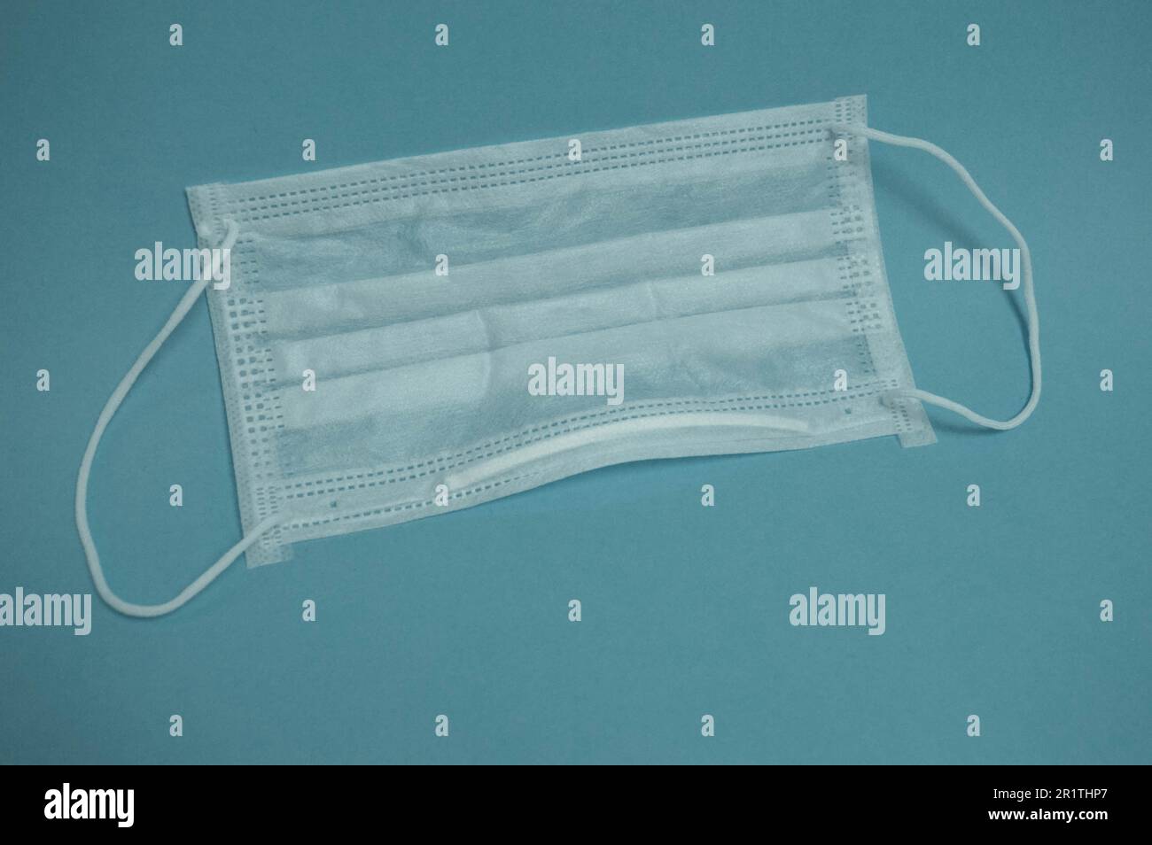 white sterile disposable mask on a blue background for the uniform of a ...