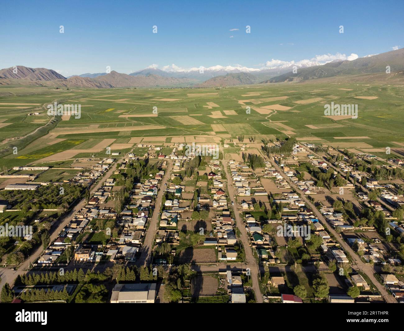 Aerial view of the village of Toguz Bulak, surrounded by farms in ...