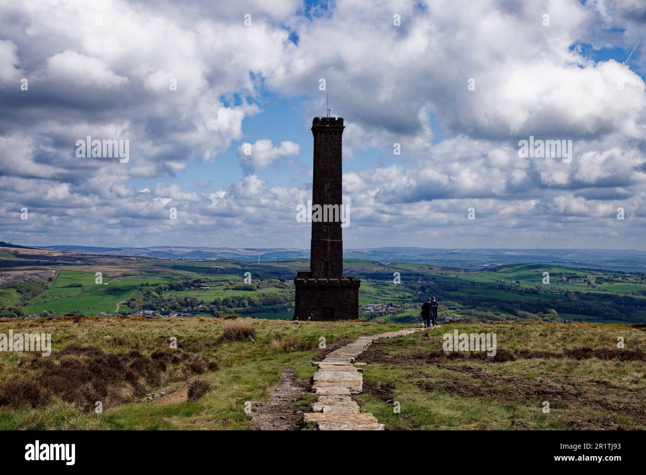 A couple walk along a path at the Peel Tower, Ramsbottom, England Stock ...