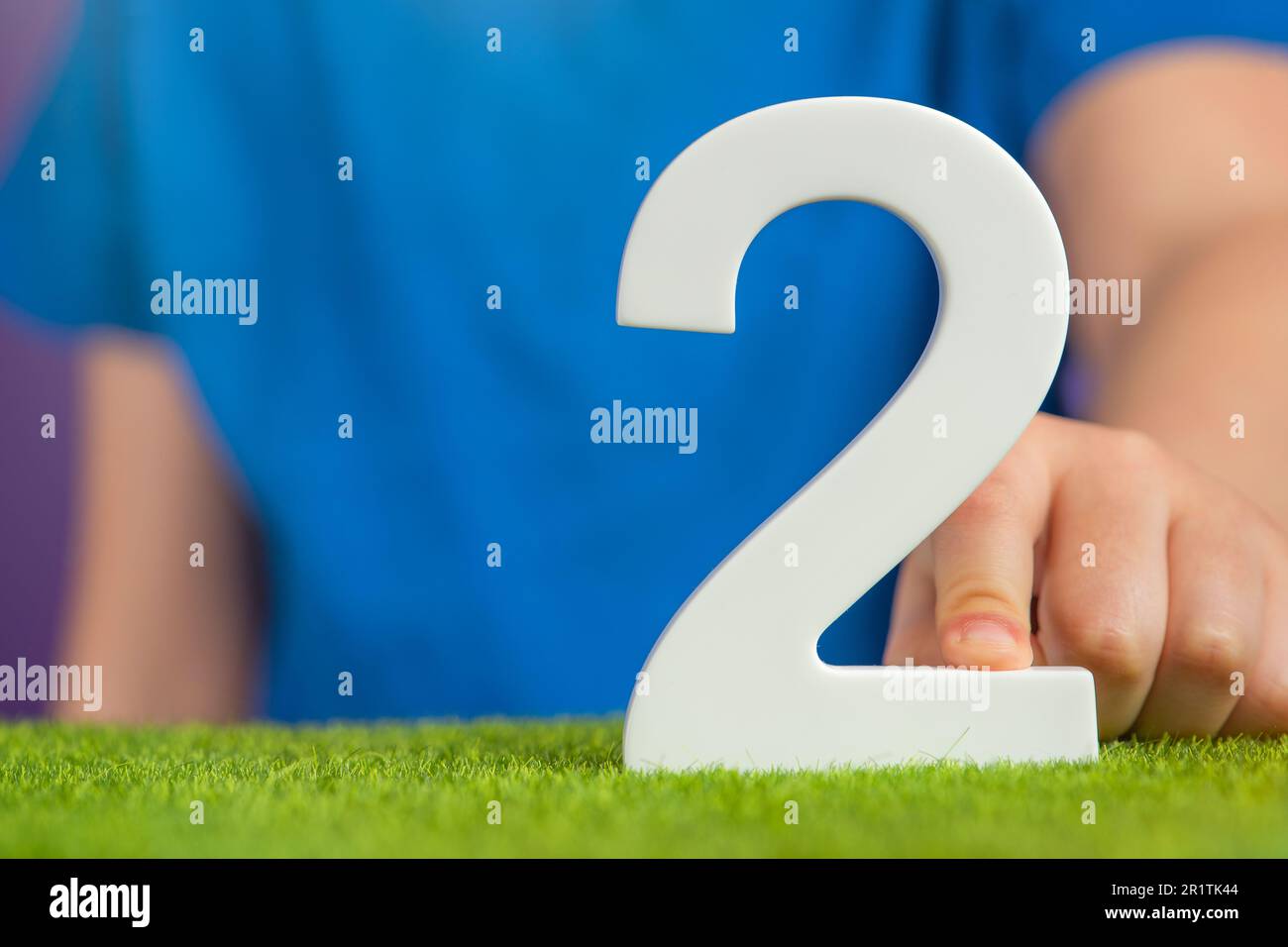 White number 2 in hand. The hand holding the number 2 symbolizes choice ...