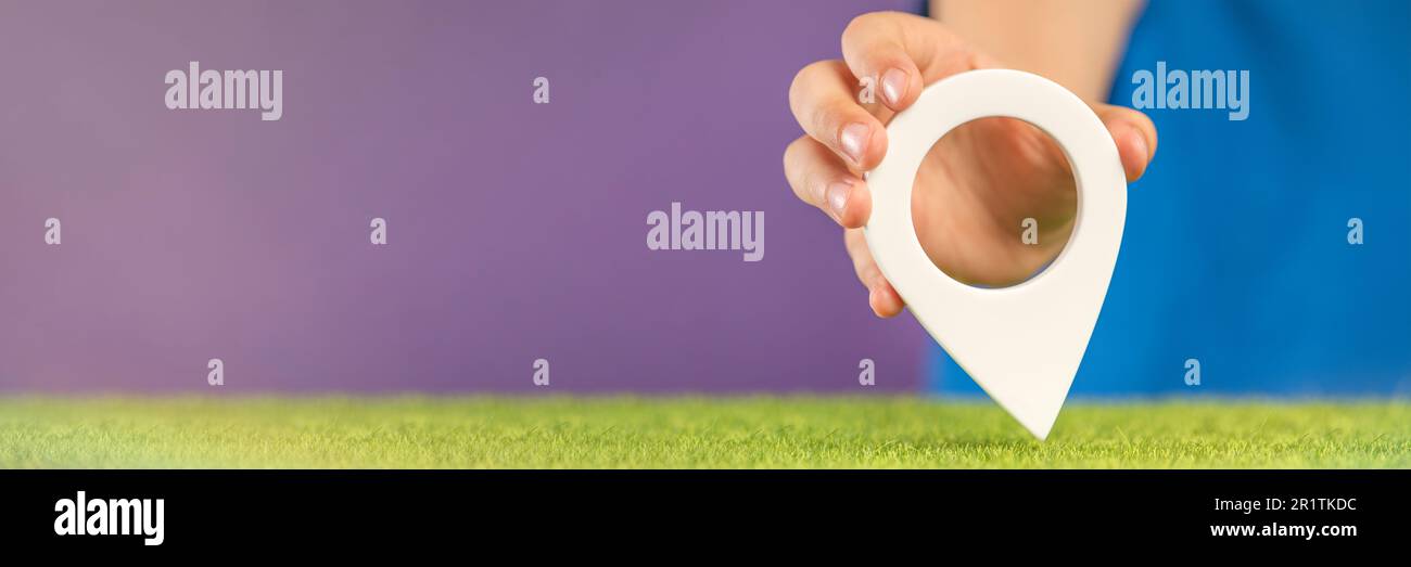 Pin icon or travel nautical map. GPS direction indicator. A hand holds ...