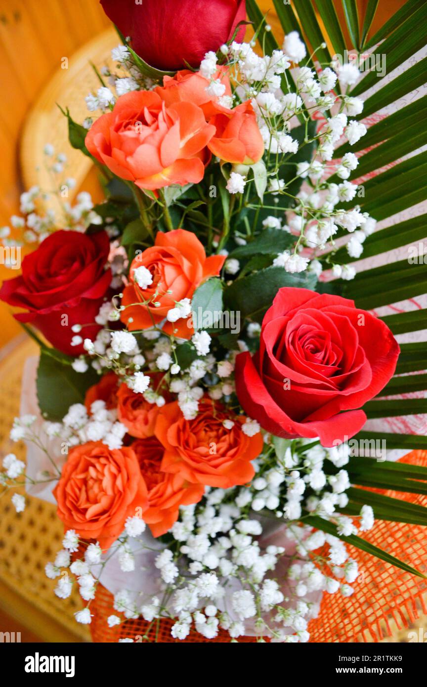 Red and yellow roses in a bouquet with interspersed white flowers Stock ...