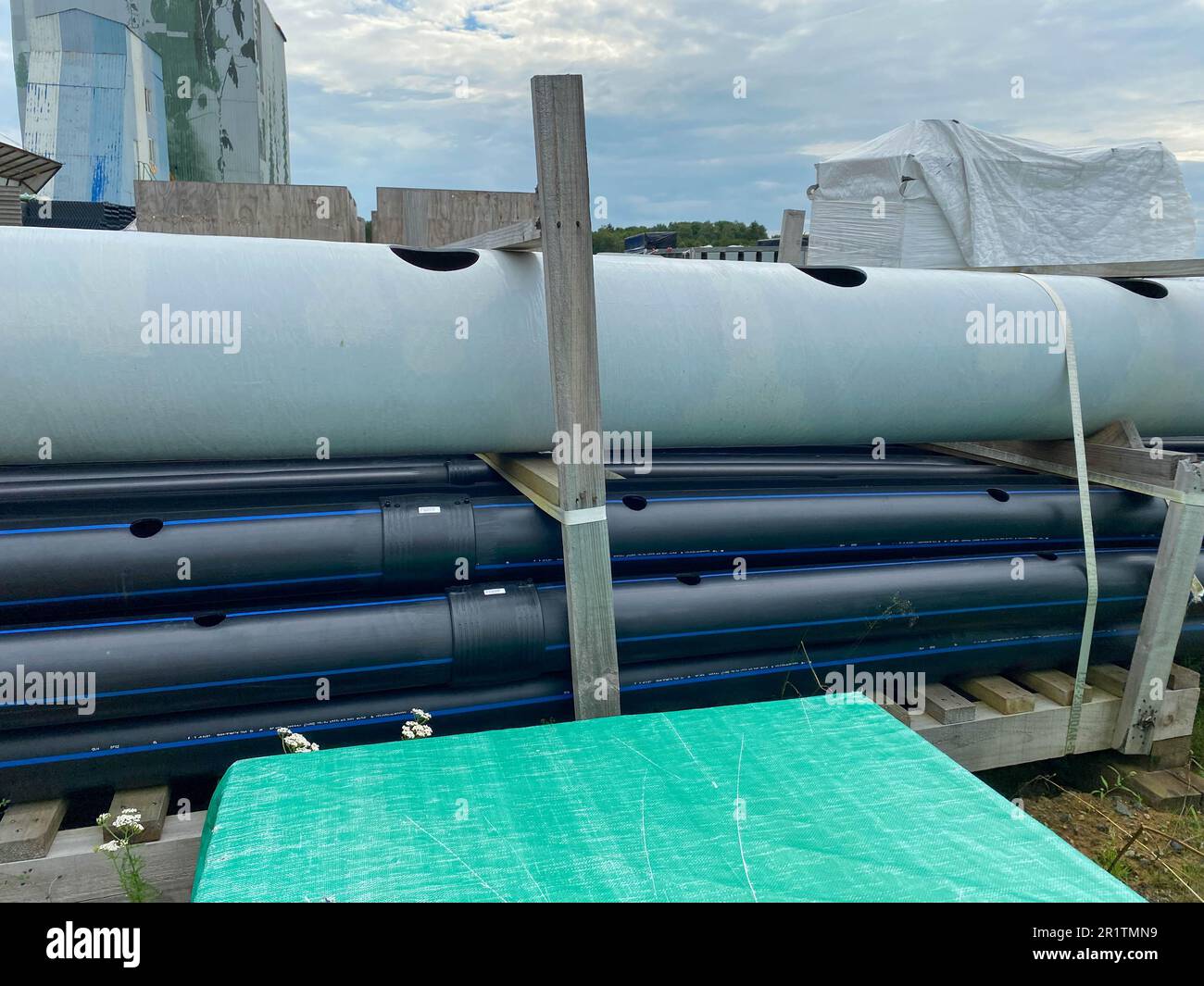 Large plastic pipes of large diameter with flanges in an open-air ...