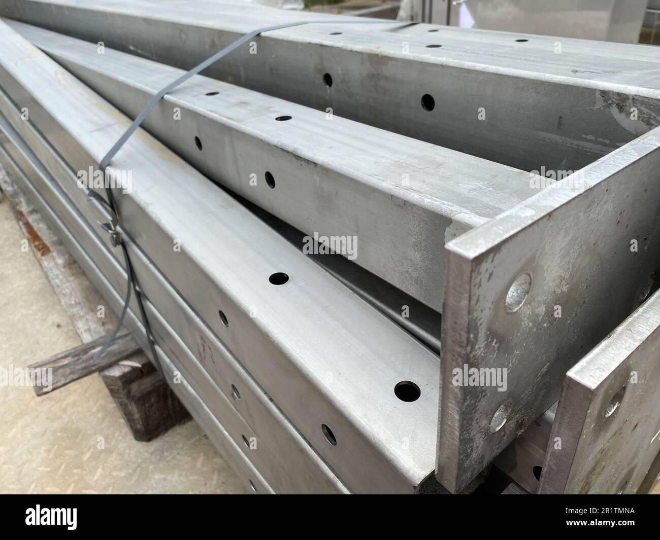 Metal structures for construction and pipes on pallets in an open-air ...