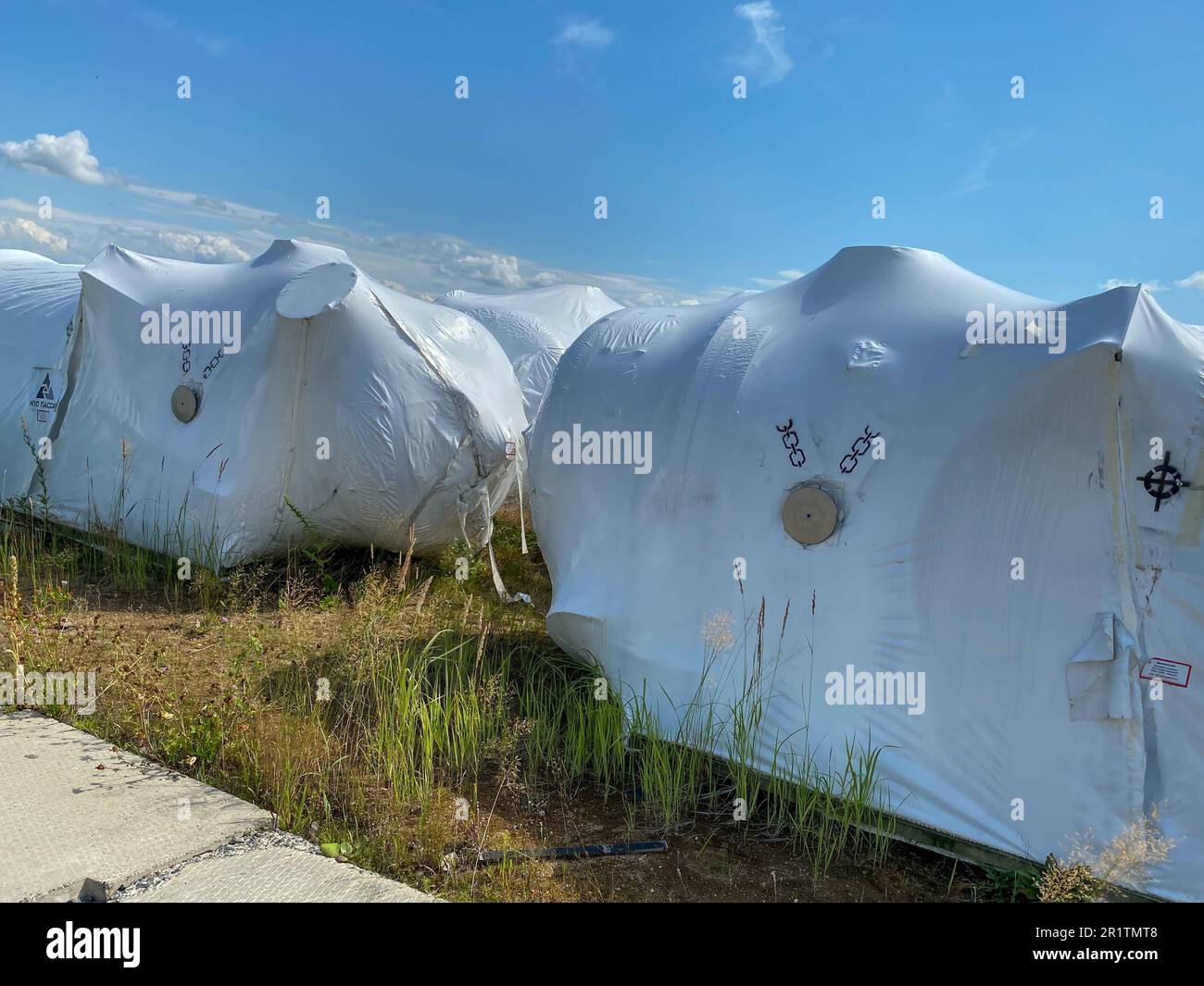 Large heat exchangers are packed in film in the warehouse of industrial ...